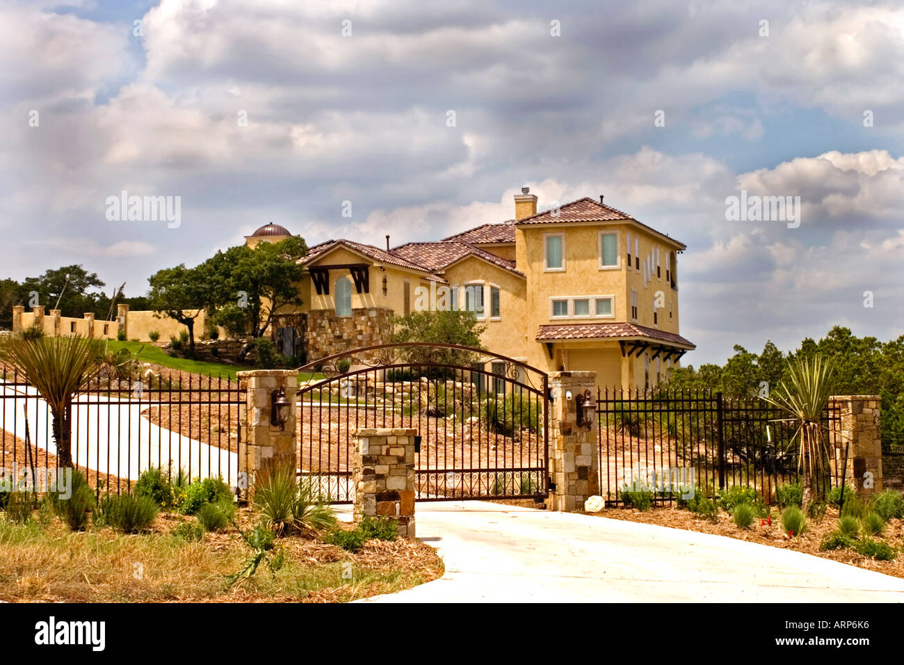 Mansion on hill behind fence Stock Photo - Alamy
