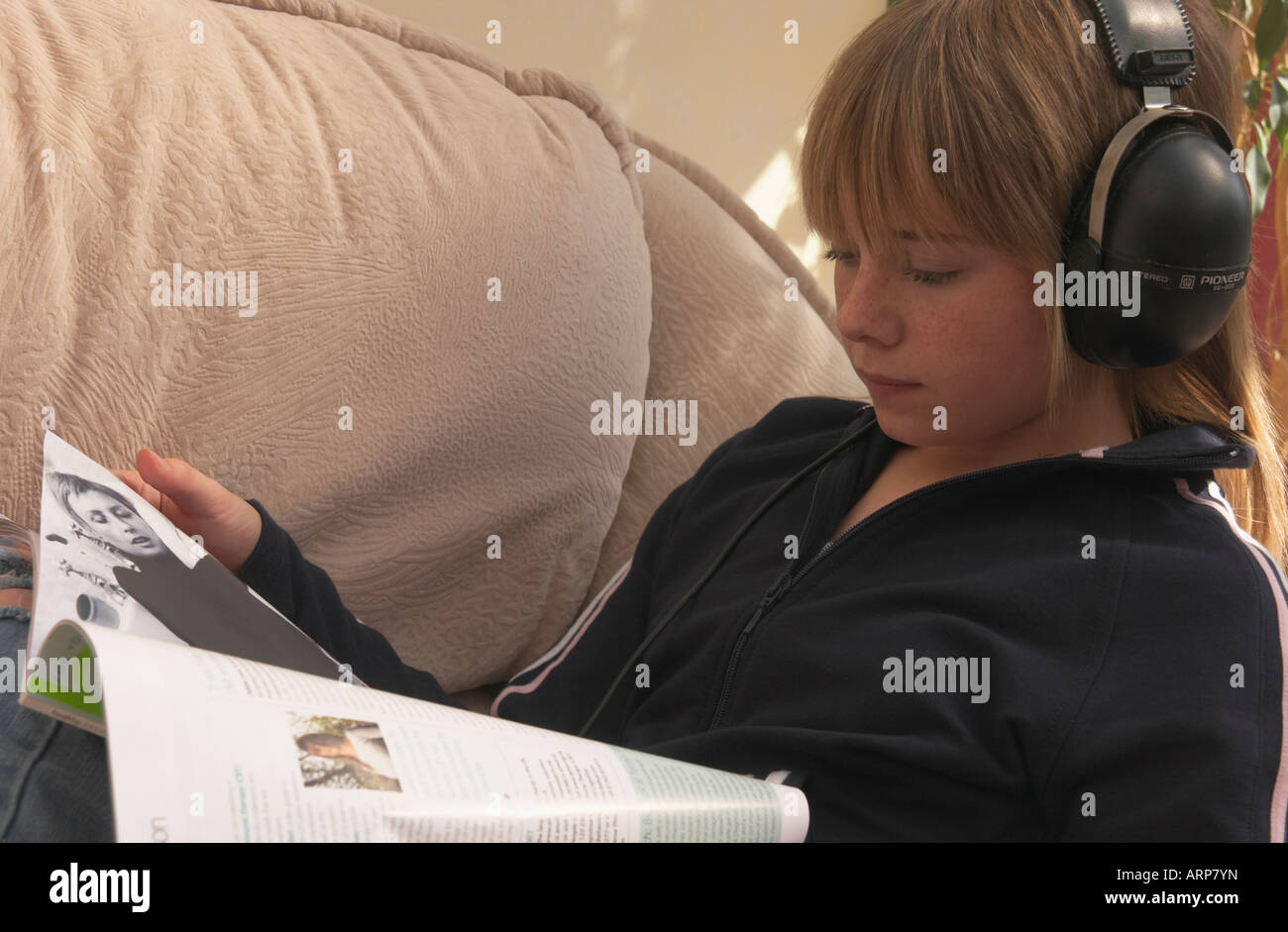 Teenage Girl Reading Magazine Wearing Headphones Stock Photo - Alamy