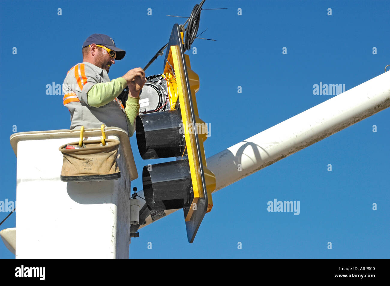 Electrician working on new turn signals on highway for better traffic ...