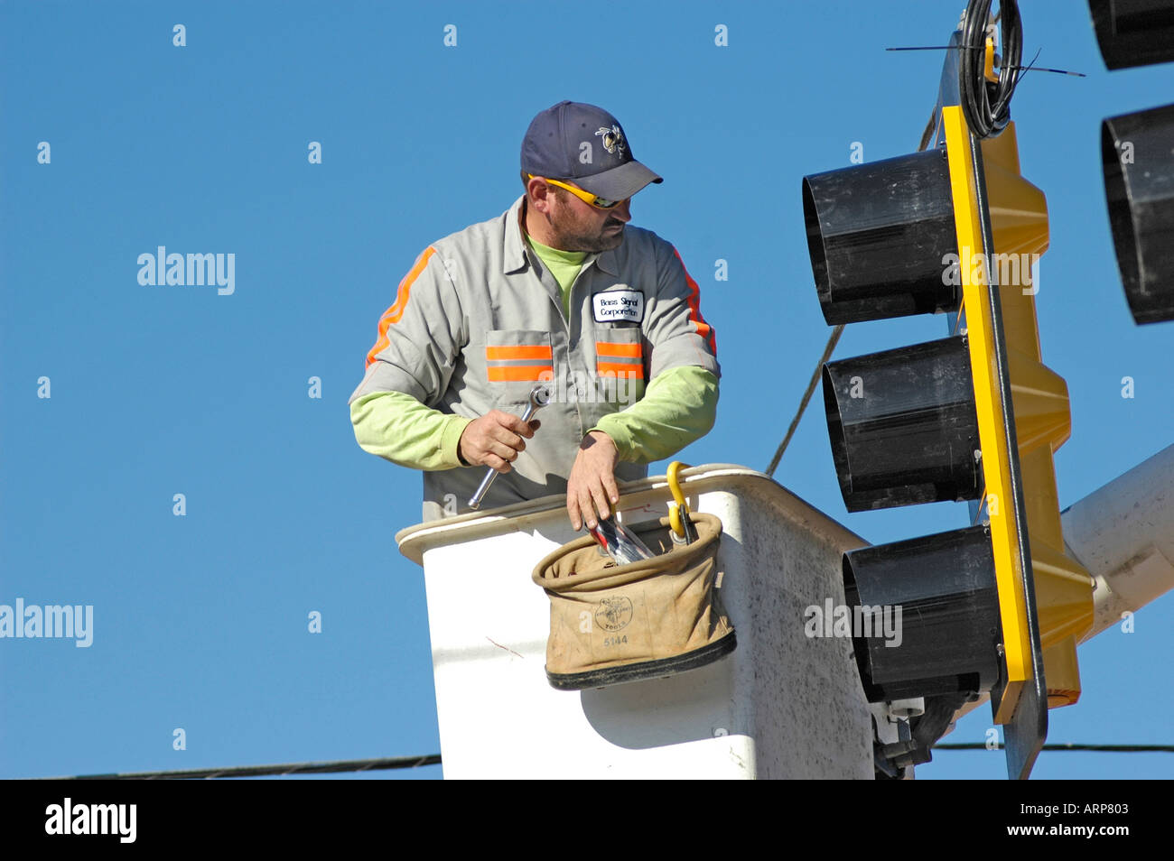 Electrician working on new turn signals on highway for better traffic ...