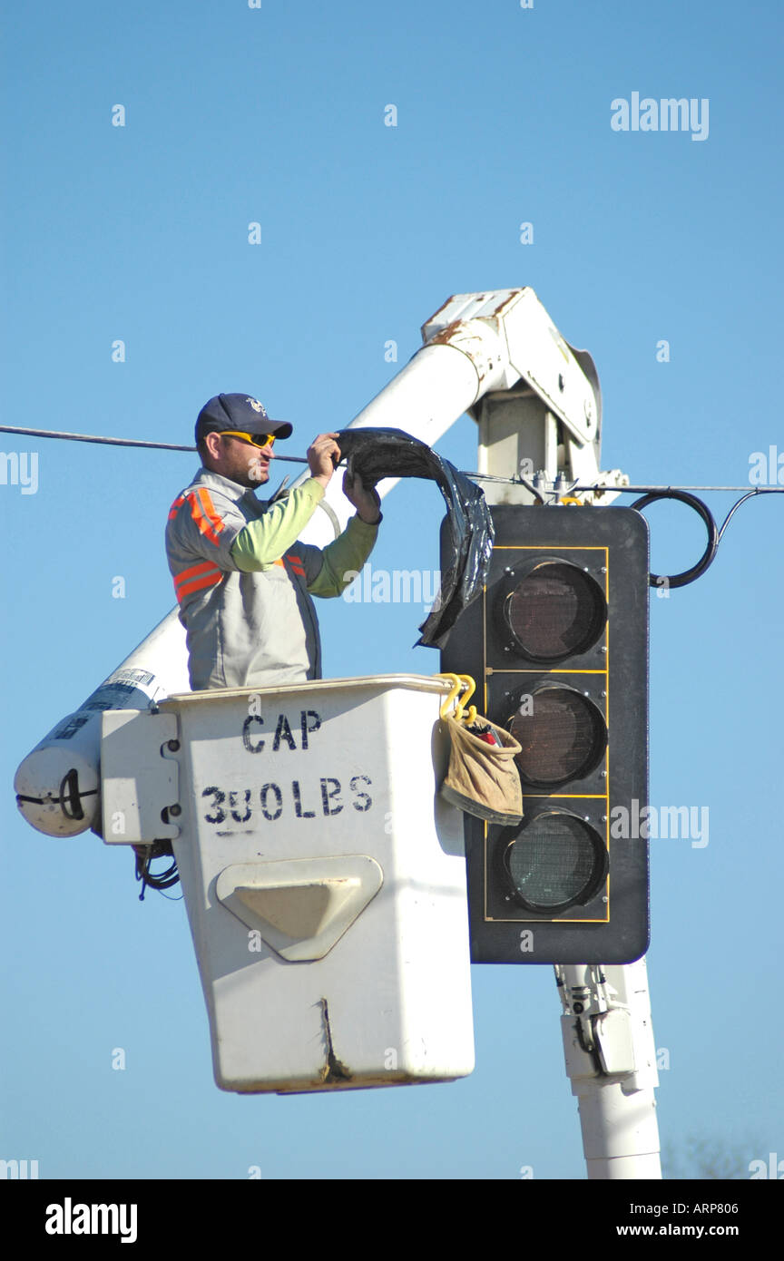 Electrician working on new turn signals on highway for better traffic ...