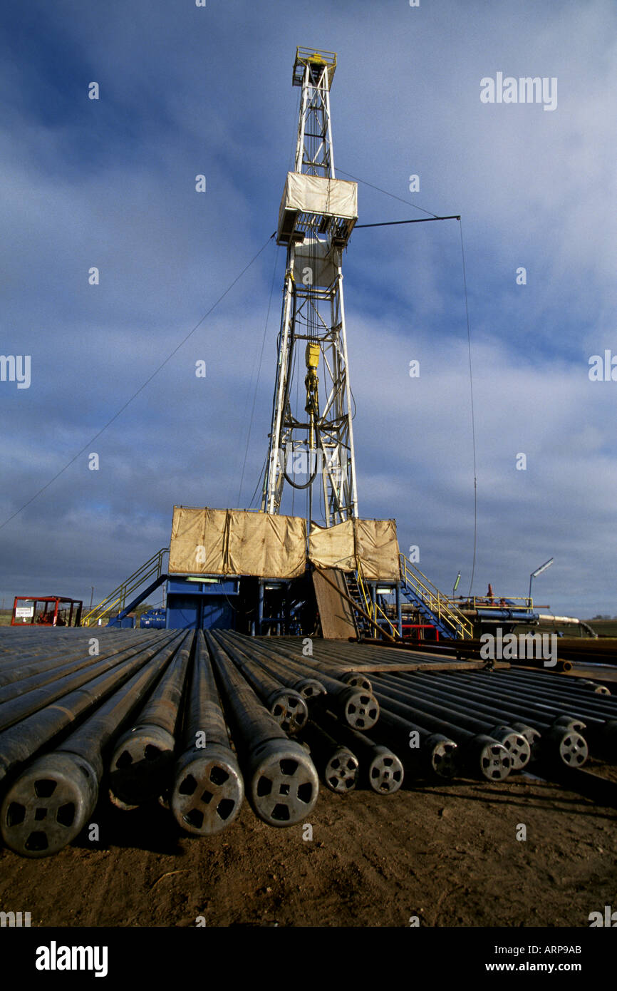 Drilling pipe sections lay on ground near oil well drill rig Snyder ...