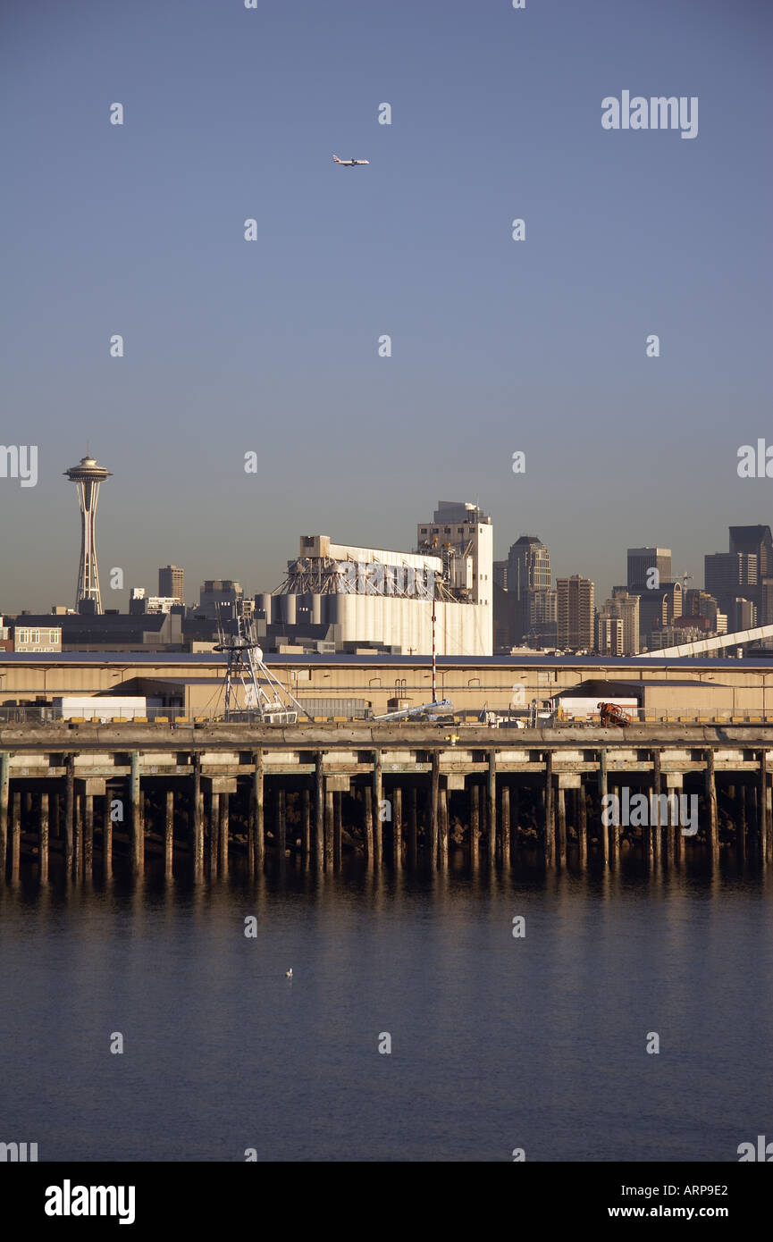 Wooden pilings support wharf with grain terminal silo and Seattle ...