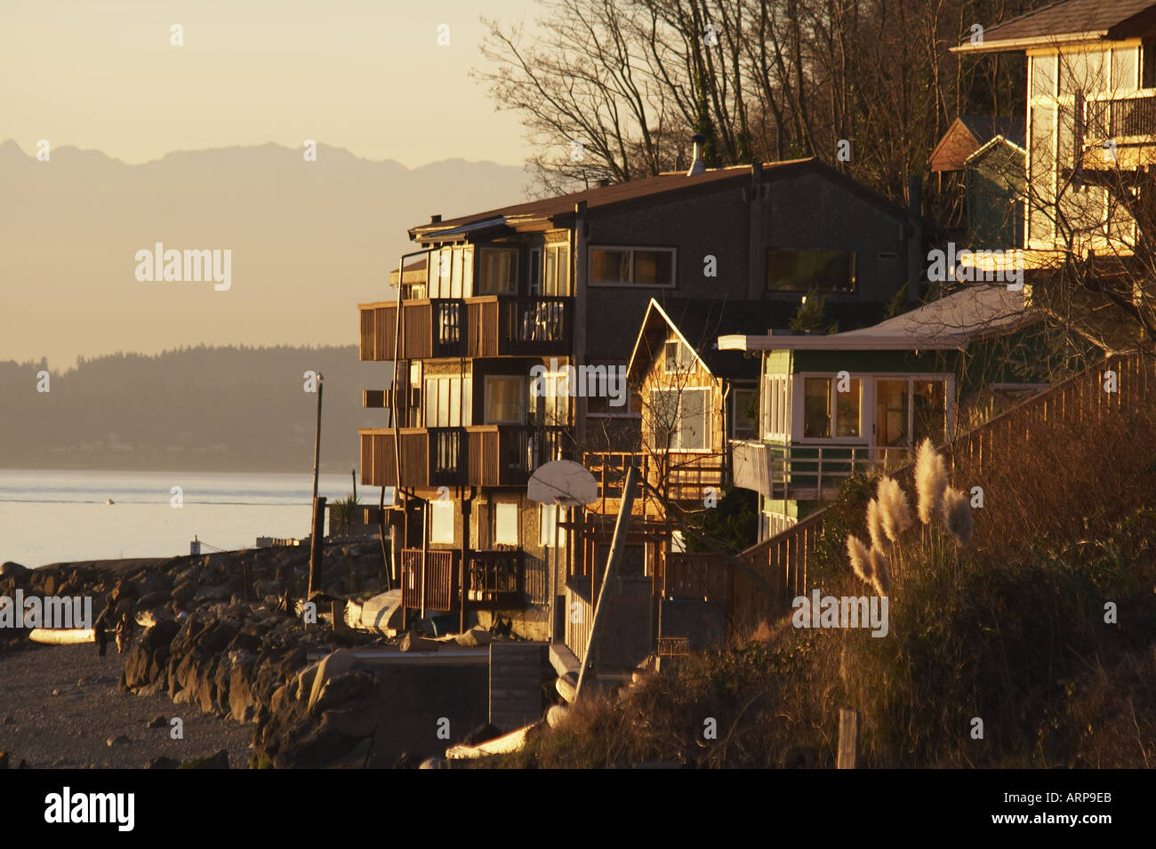 Beachfront homes on Puget Sound with Olympic Mountain range in ...