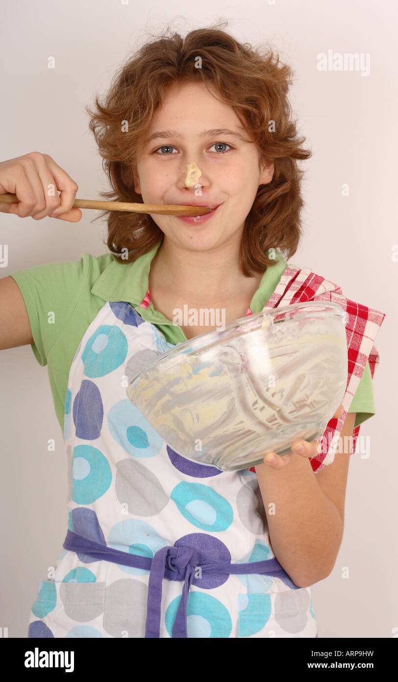 Child cooking cake licking spoon hi-res stock photography and images ...