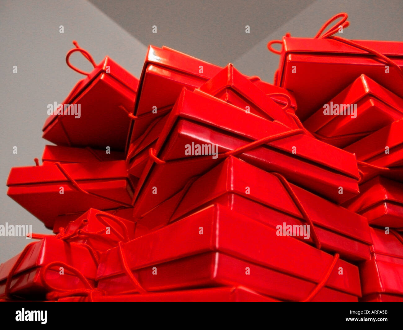 Christmas presents in bright red boxes are piled up waiting to be ...