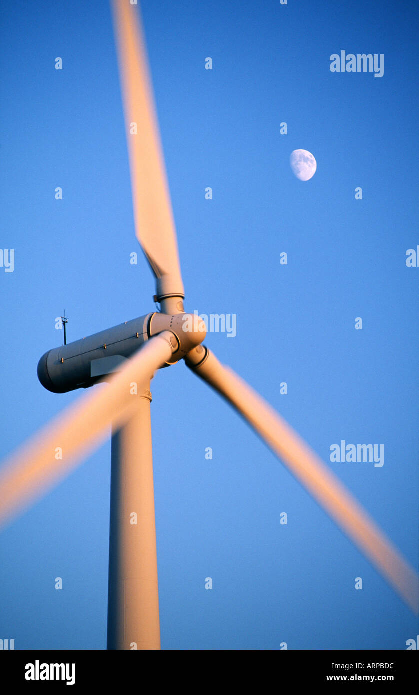 Wind turbine rotors with blue sky and moon generating electricity on ...