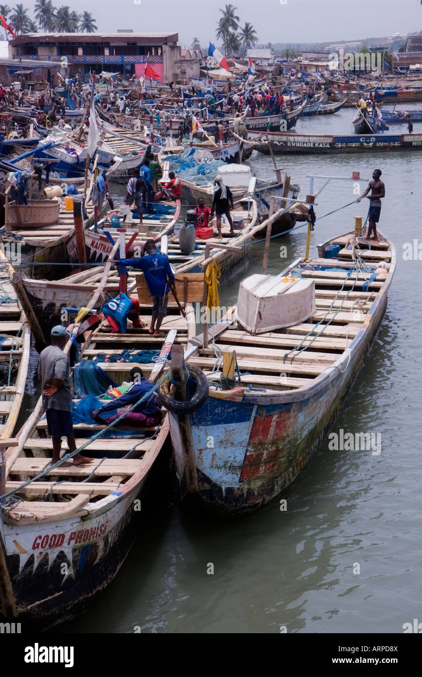 Colorful traditional fishing boats come to port in Elmina Ghana Stock ...