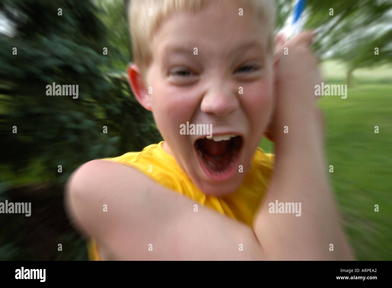 Boy Yelling and Swinging Stock Photo - Alamy