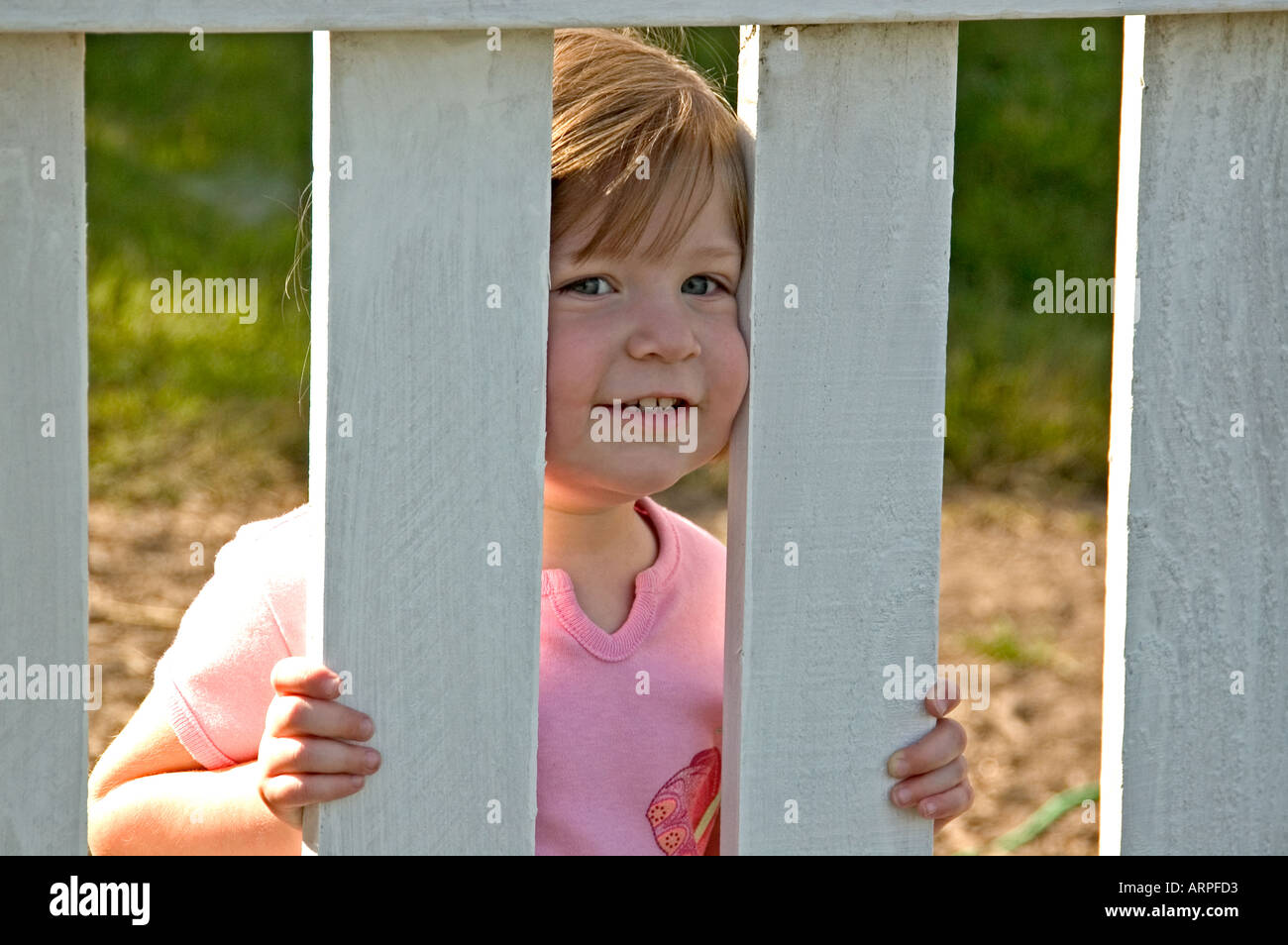 Baby Peeking Over Fence