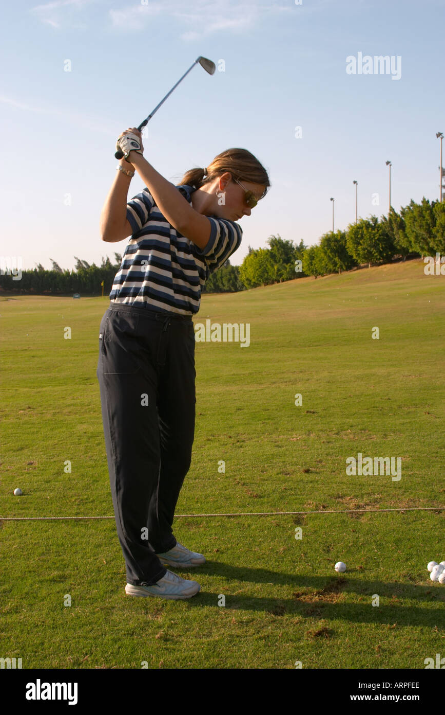 Woman playing golf Stock Photo - Alamy