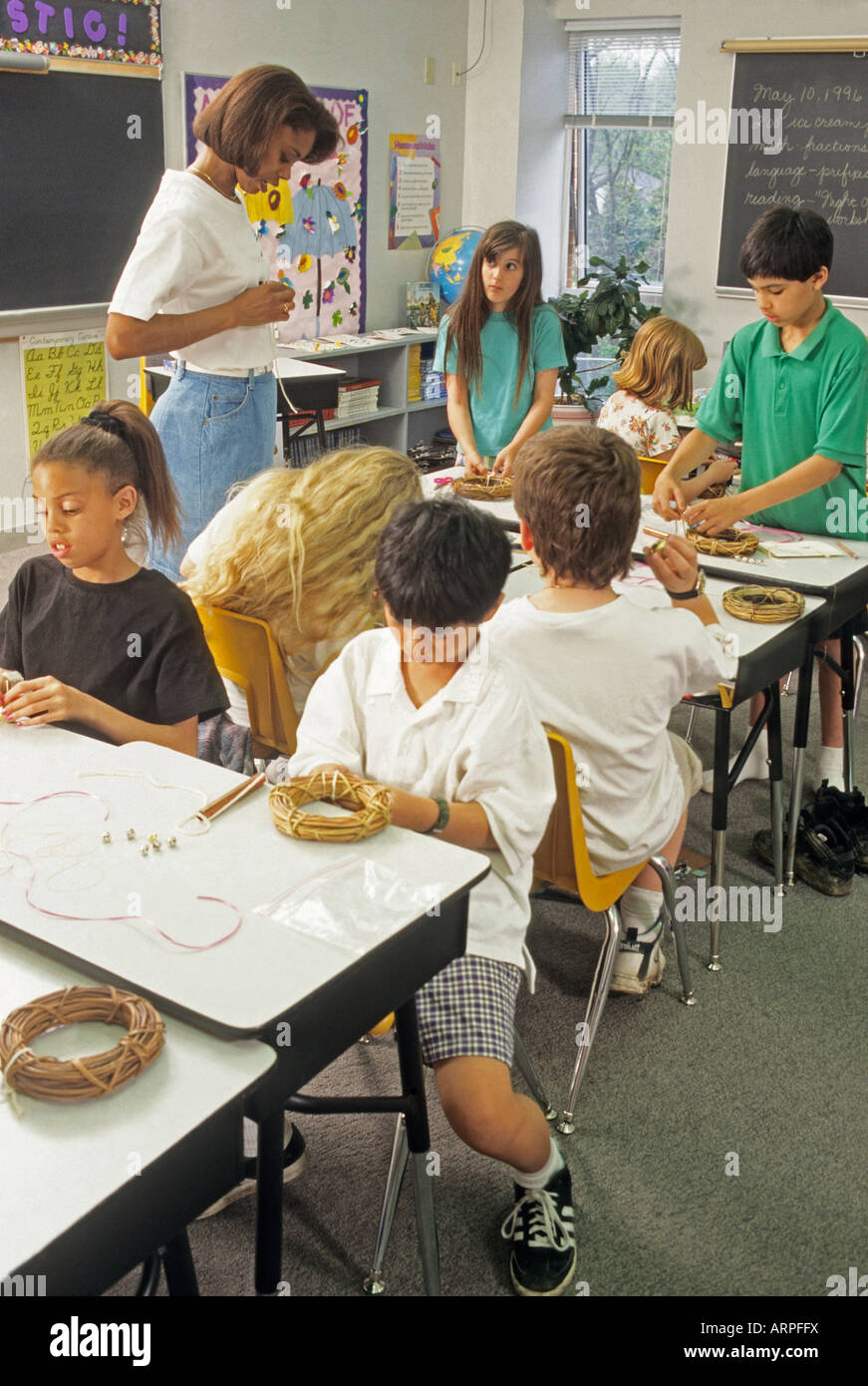 Teacher helps fourth grade class with craft, education, Ohio USA Stock ...