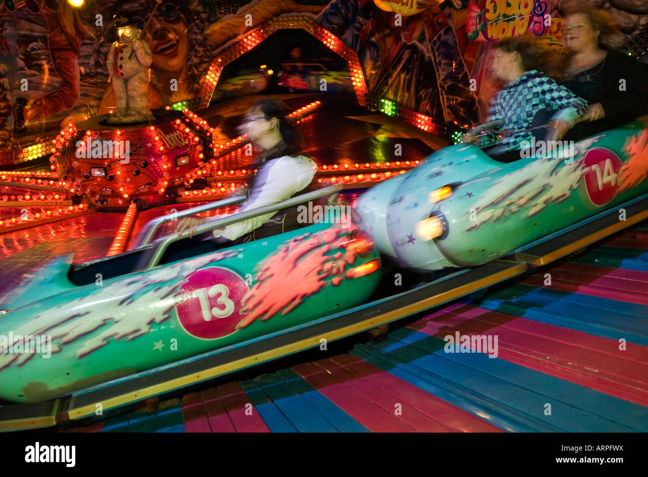 Adults at a fair ride Stock Photo - Alamy
