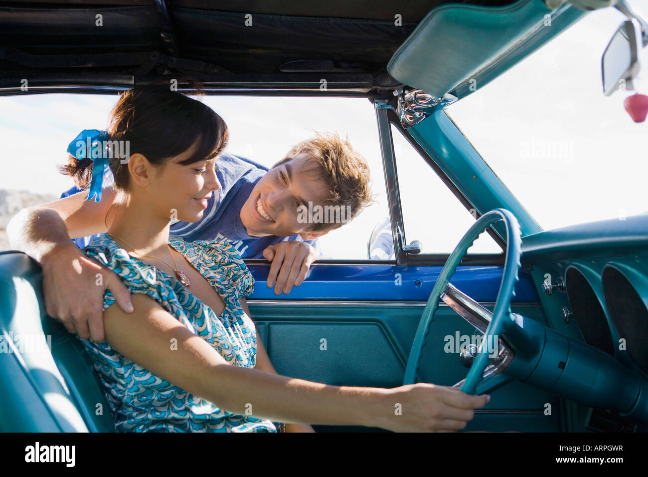 Man leaning into car Stock Photo - Alamy