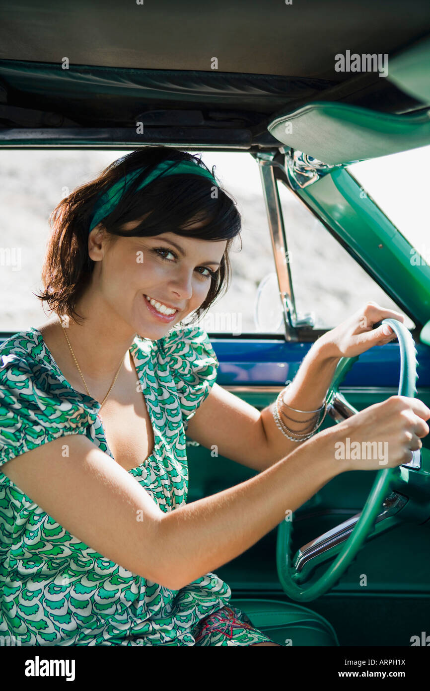 Woman in car smiling at camera Stock Photo - Alamy