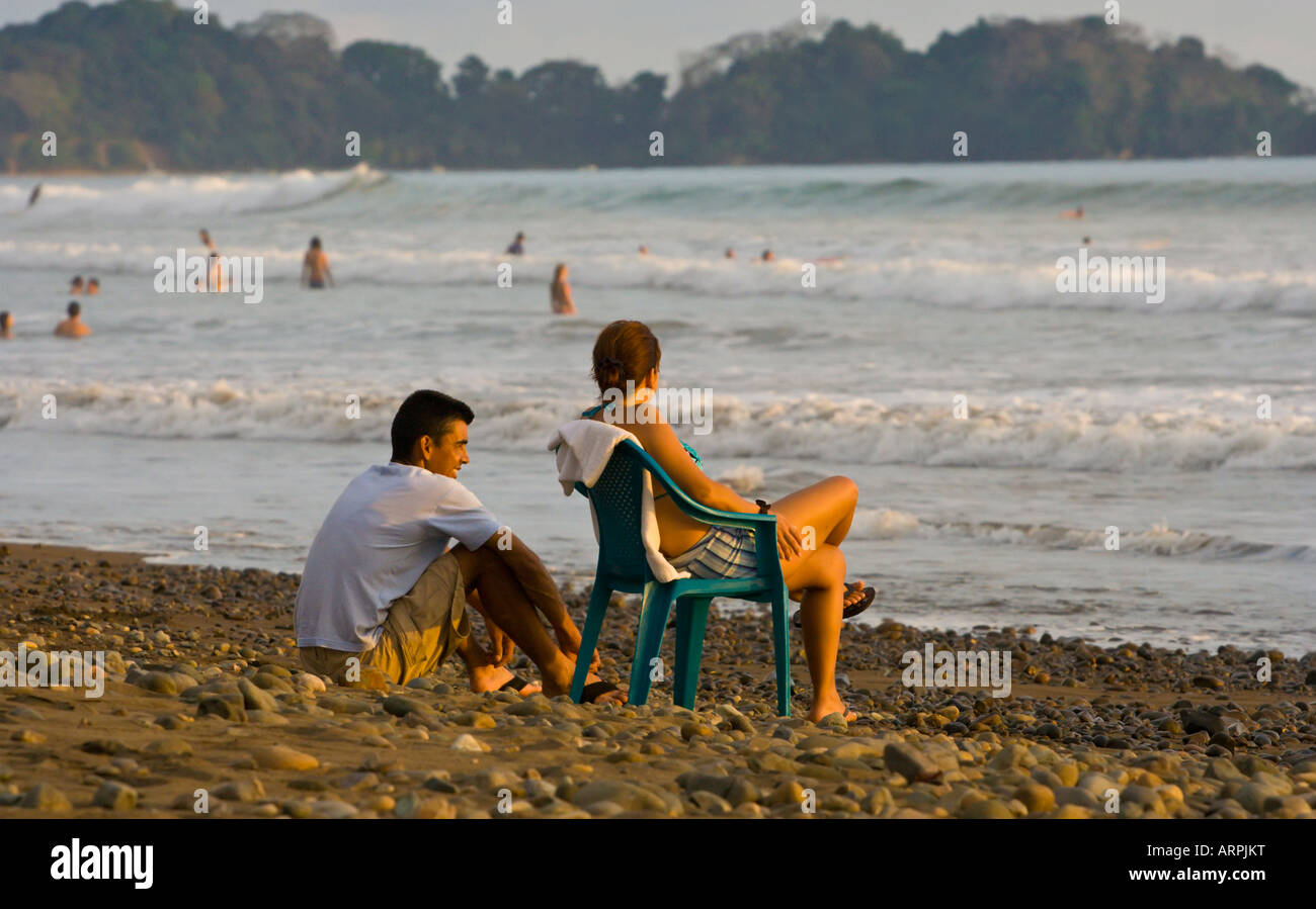 Couple enjoying the sunset on the beach at Dominical Costa Rica Stock ...