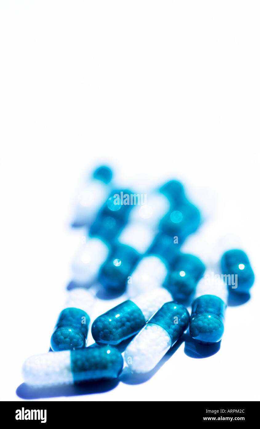 Vertical close up of blue and white medical pills capsules drugs blue ...