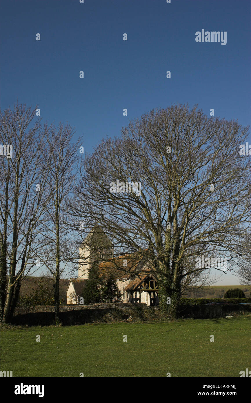 The Parish Church of St Andrew set behind winter trees in the village ...