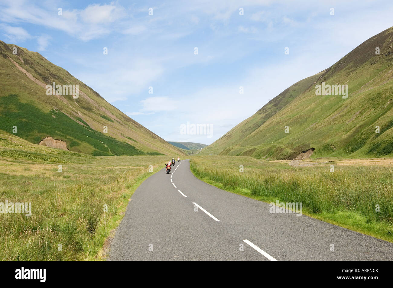 3 motorcyclists touring the Southern Uplands landscape along the A708 ...