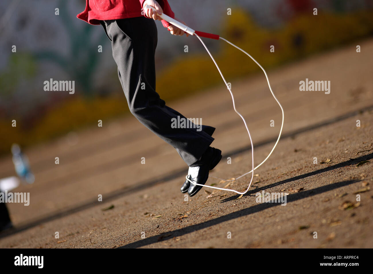 Children skipping in a school playground Stock Photo - Alamy