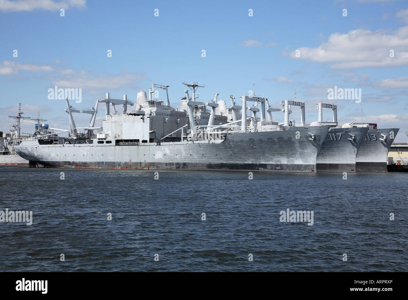 Three Amphibious Cargo Ships (LAK class) moored in a line out from dock ...