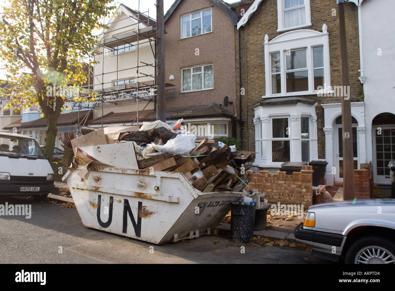 Overloaded Skip in road, full of DIY rubbish outside private ...