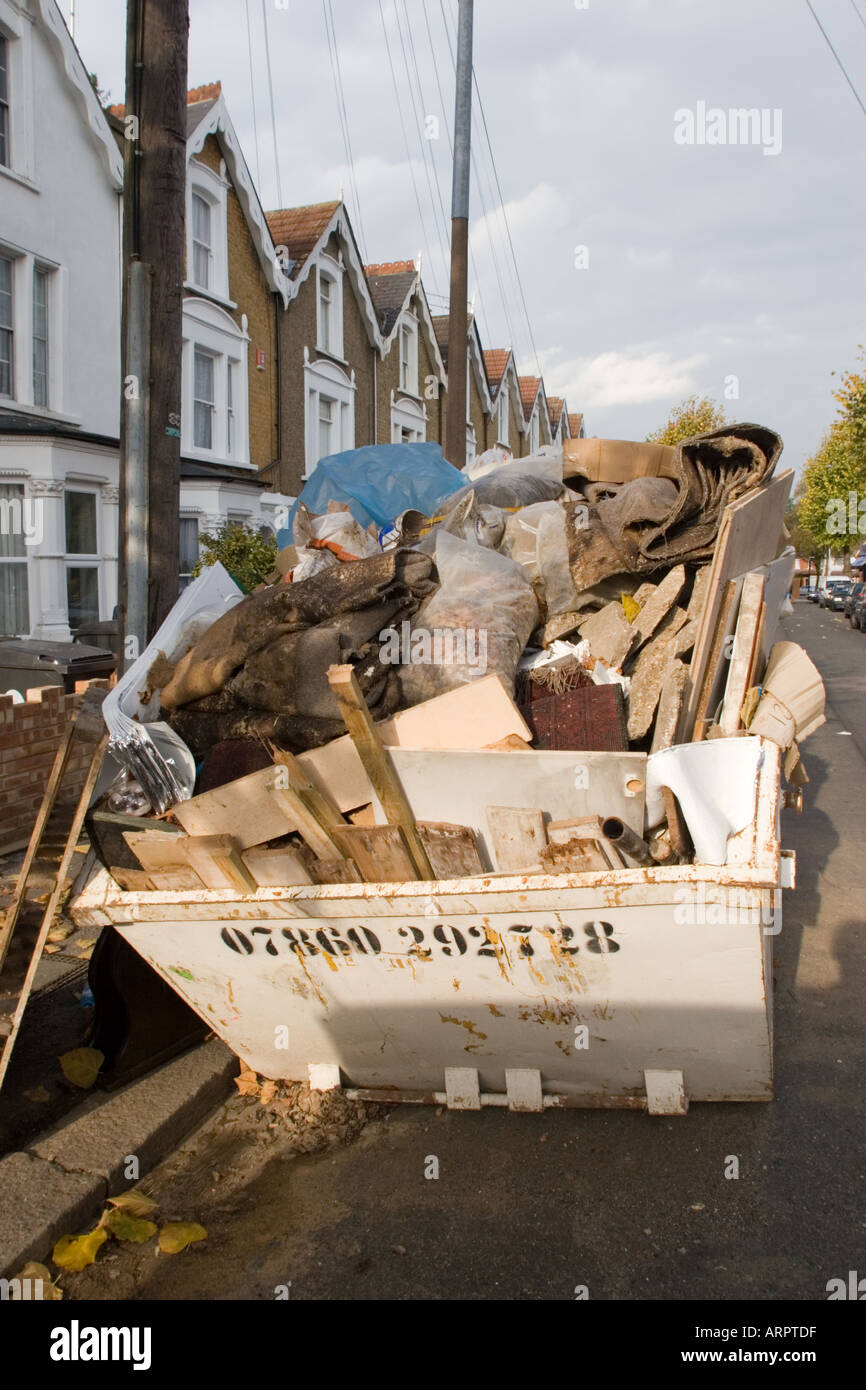 Overloaded Skip in road. Full of DIY rubbish outside private ...