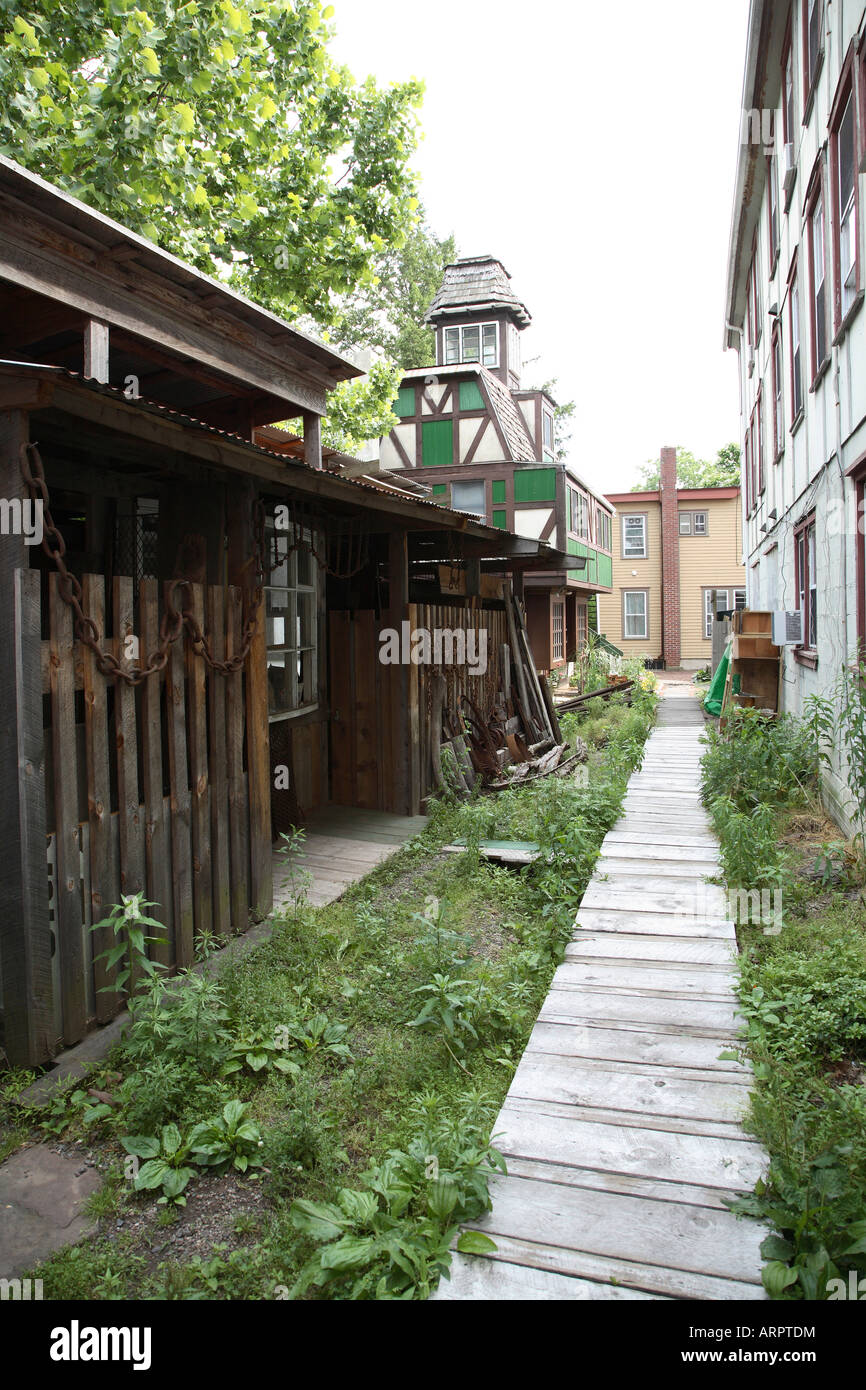 Long narrow wooden walkway beside rustic iron workshop Stock Photo - Alamy