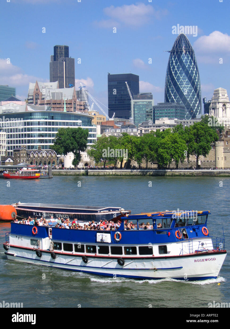 Passenger ferry passing the Tower of London with Tower 42 and The ...