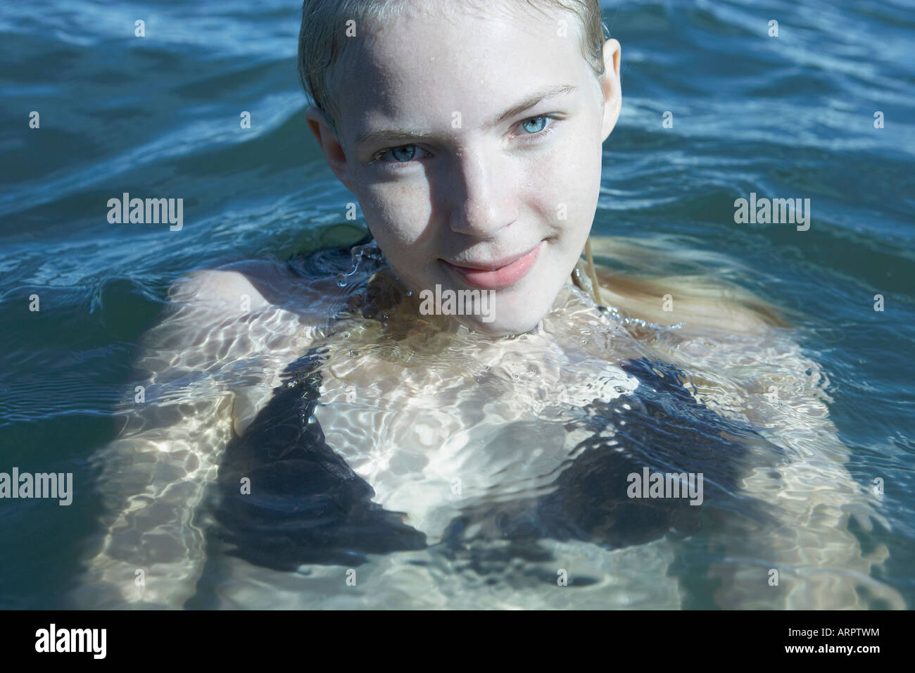 Young Woman Swimming in the Sea Stock Photo - Alamy