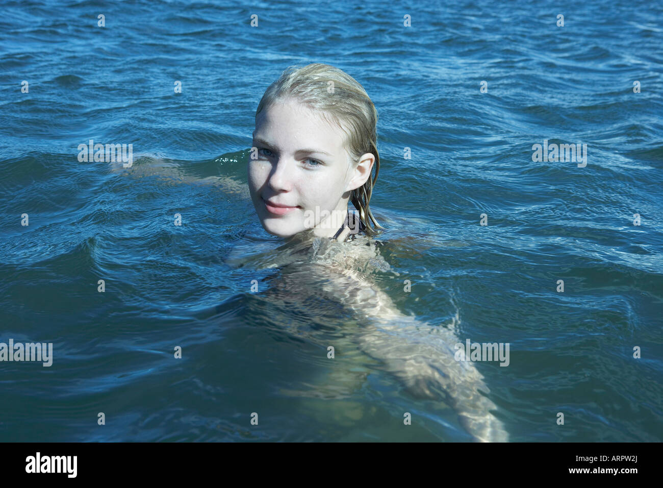 Young Woman Swimming in the Sea Stock Photo - Alamy