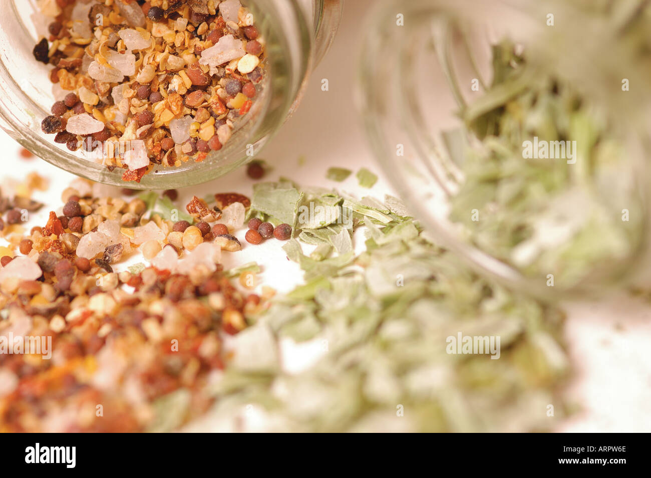 Close up of spices spilling from glass jars Stock Photo - Alamy