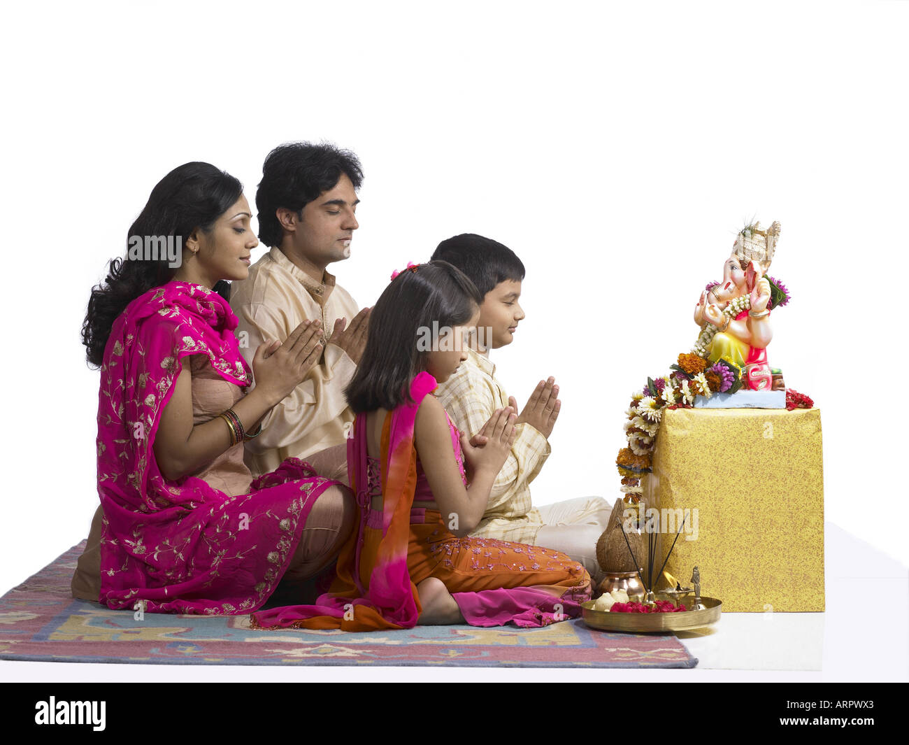 Indian family with father mother son and daughter praying to Lord ...