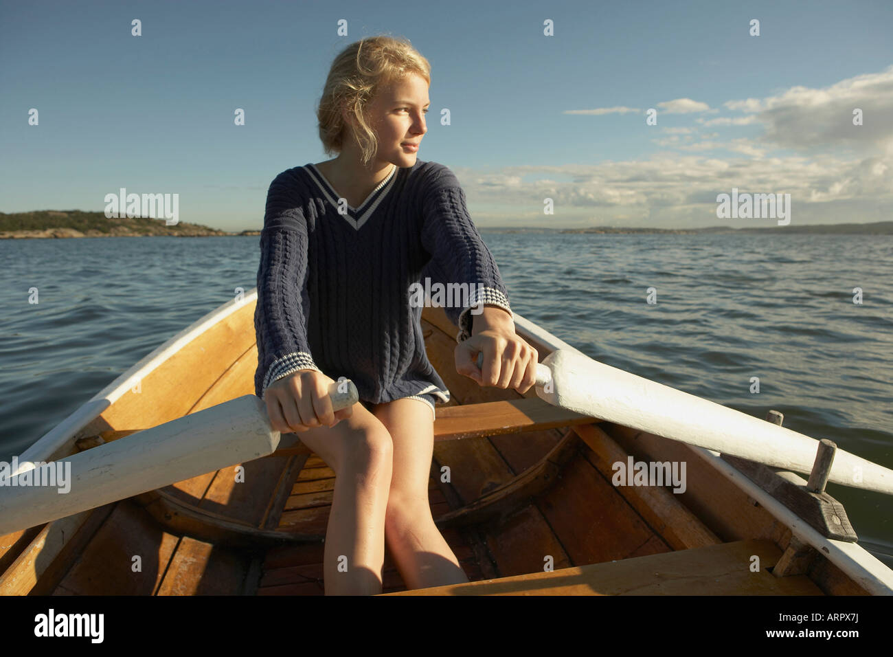 Young woman in rowing boat Stock Photo - Alamy