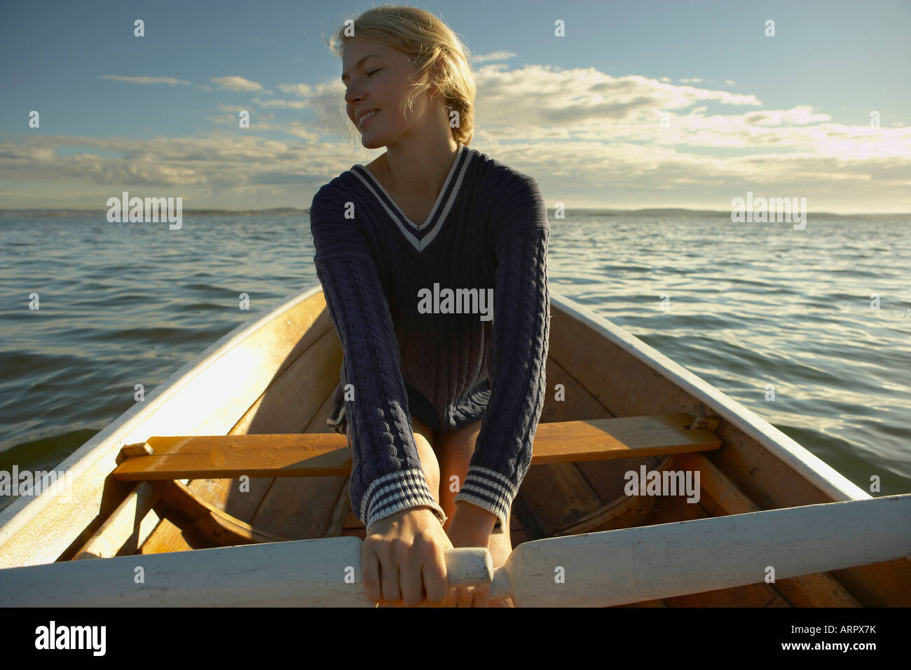 Young woman in rowing boat Stock Photo - Alamy