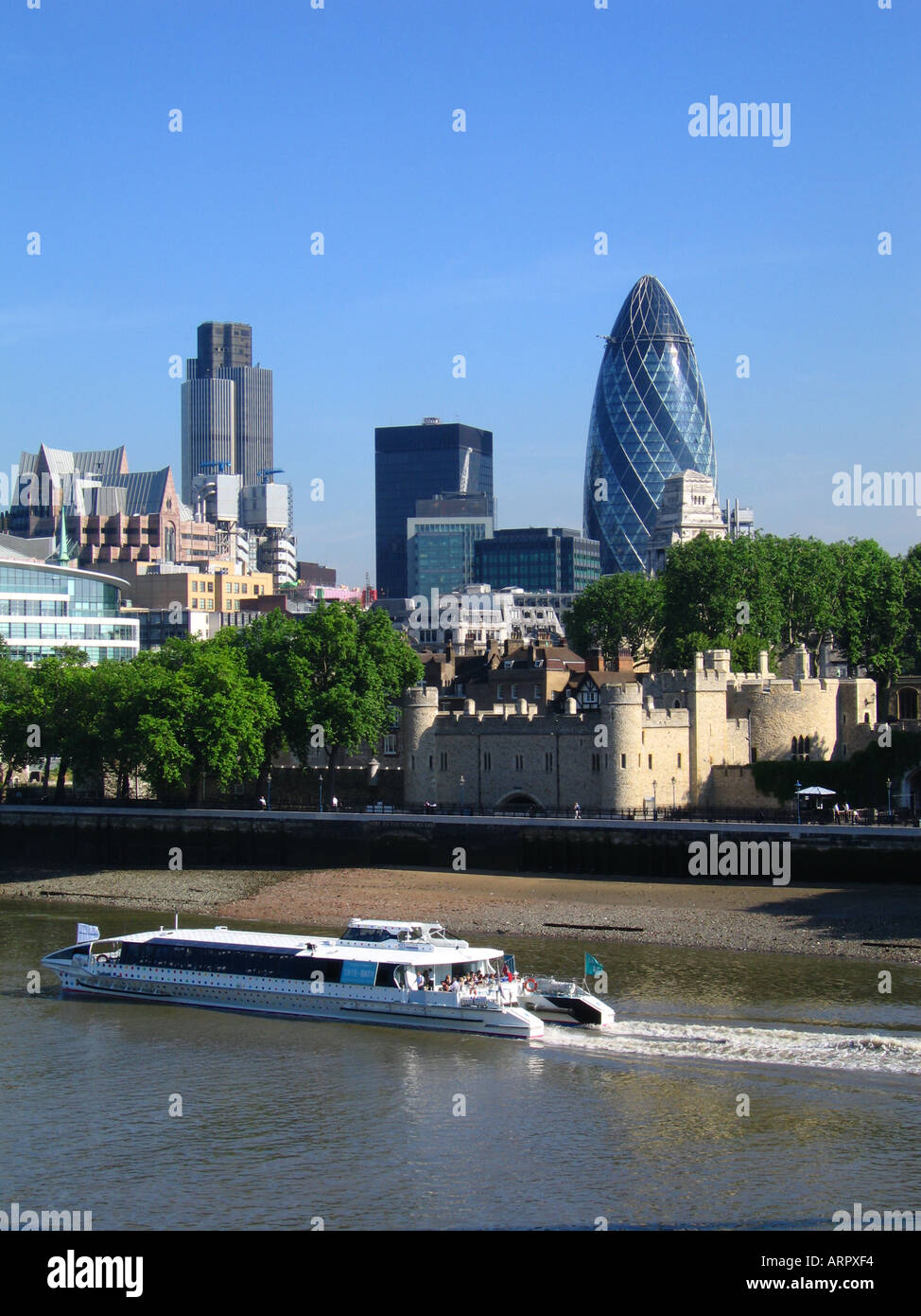 Passenger ferry passing the Tower of London with Tower 42 and The ...