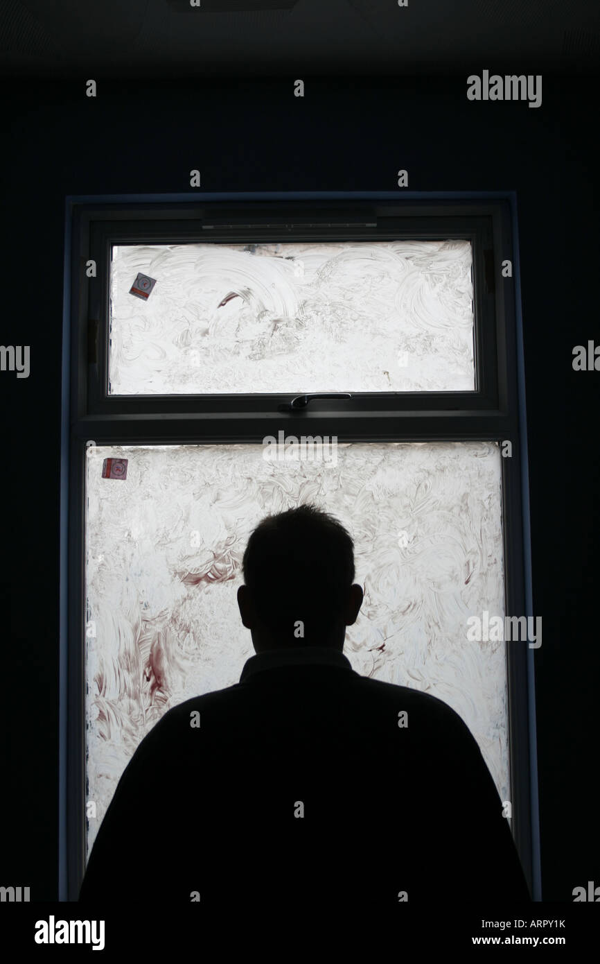 man sitting in dark room Stock Photo - Alamy