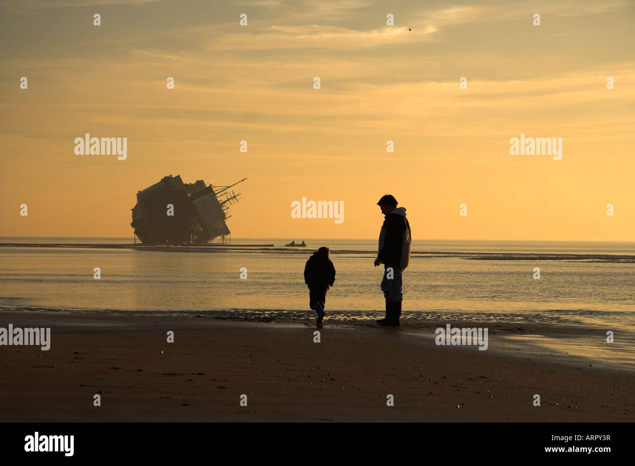 Man and boy on a beach, sunset, stricken ferry, Riverdance, Blackpool ...