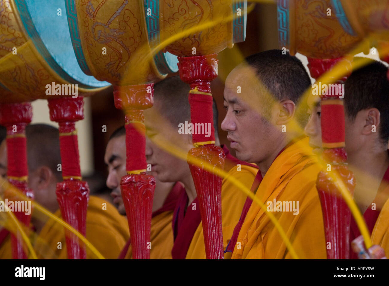 Tibetan Buddhist monks using traditional meditation instruments. close ...