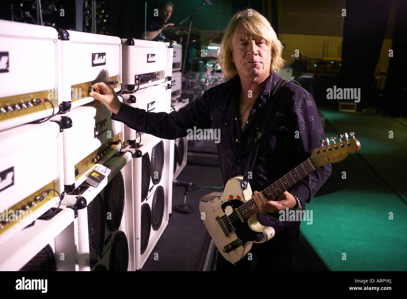 Guitarist Rick Parfitt of Status Quo adjusts his Marshall Amplifier ...