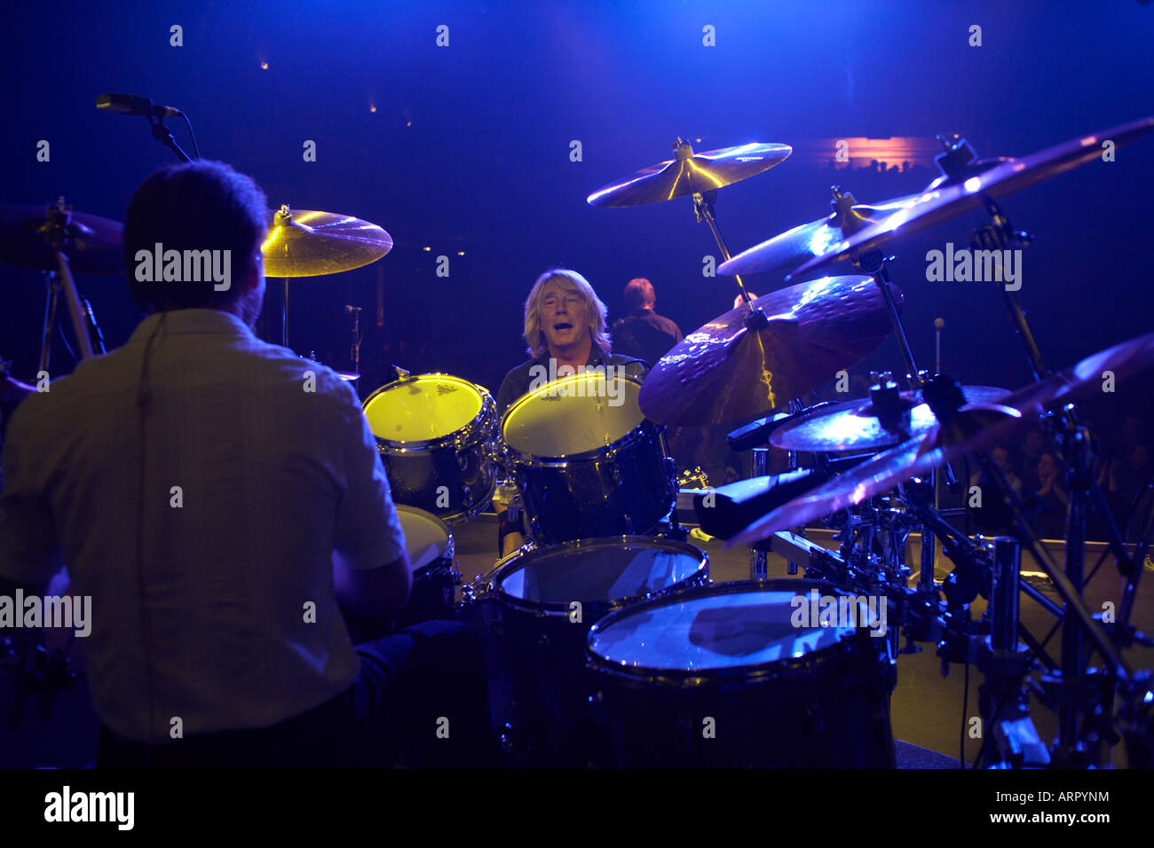 Drummer Matt Letley and blonde Rick Parfitt of Status Quo play on stage ...