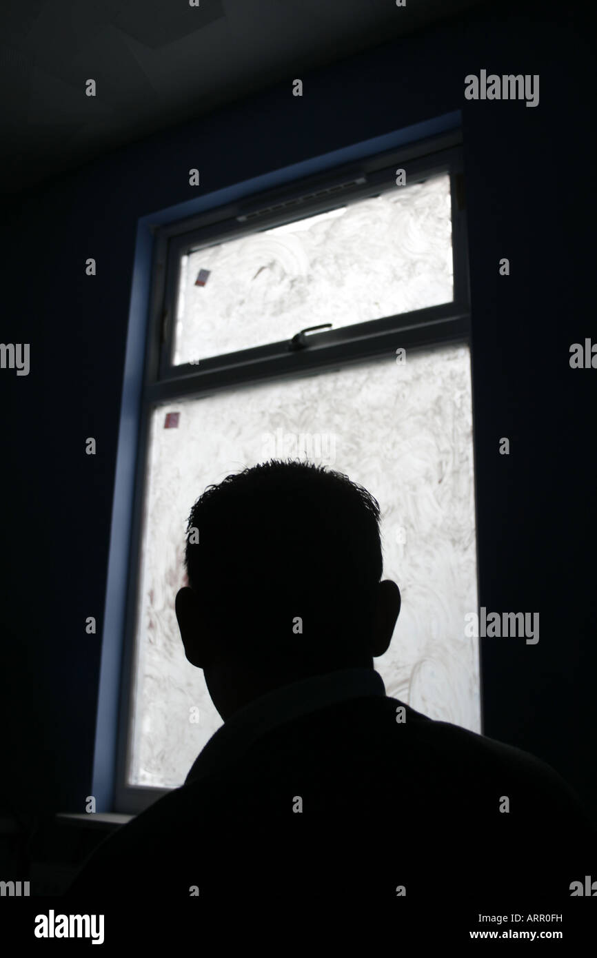 man sitting in dark room Stock Photo - Alamy