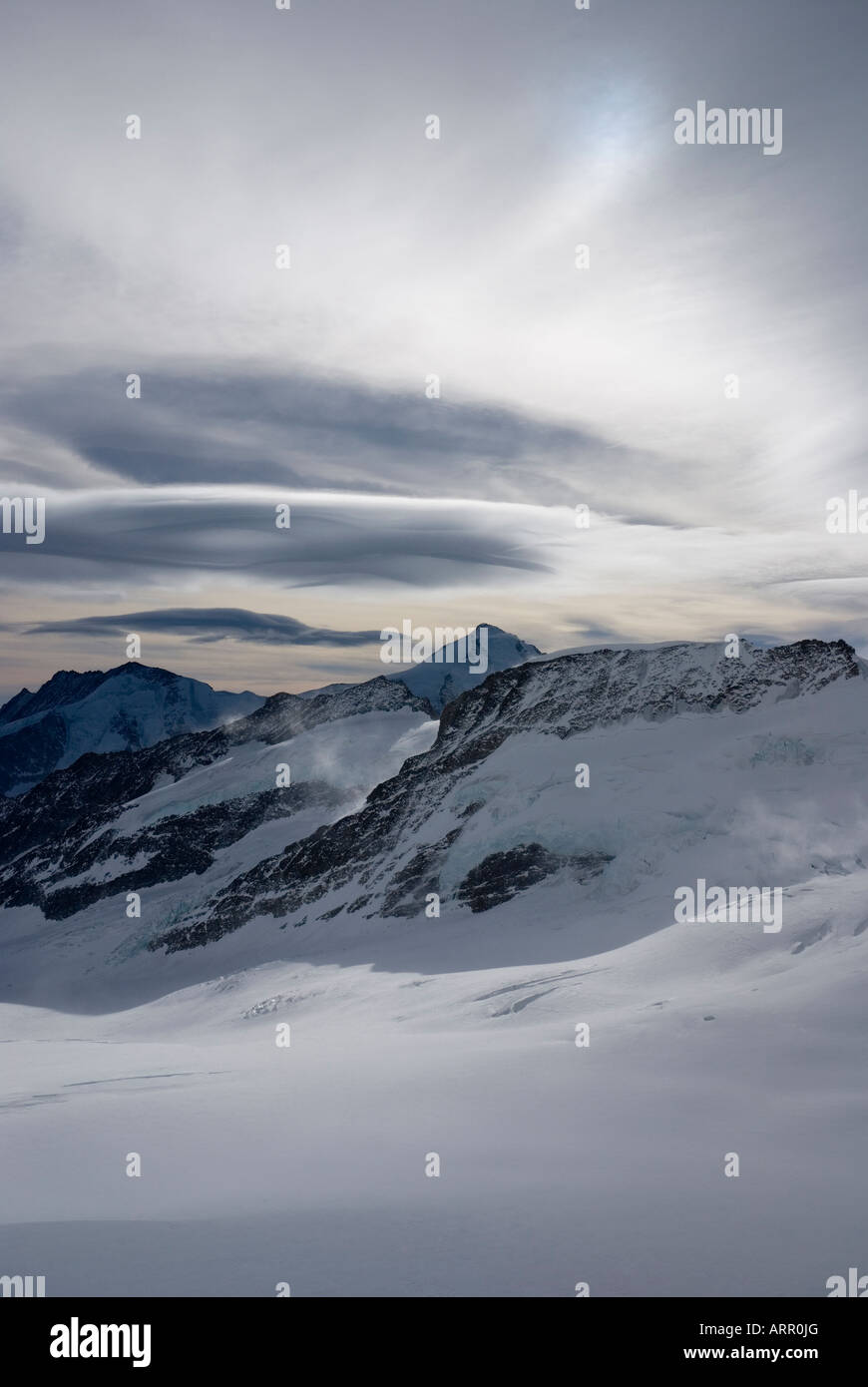 Lenticular clouds form high over the Swiss alps Stock Photo - Alamy