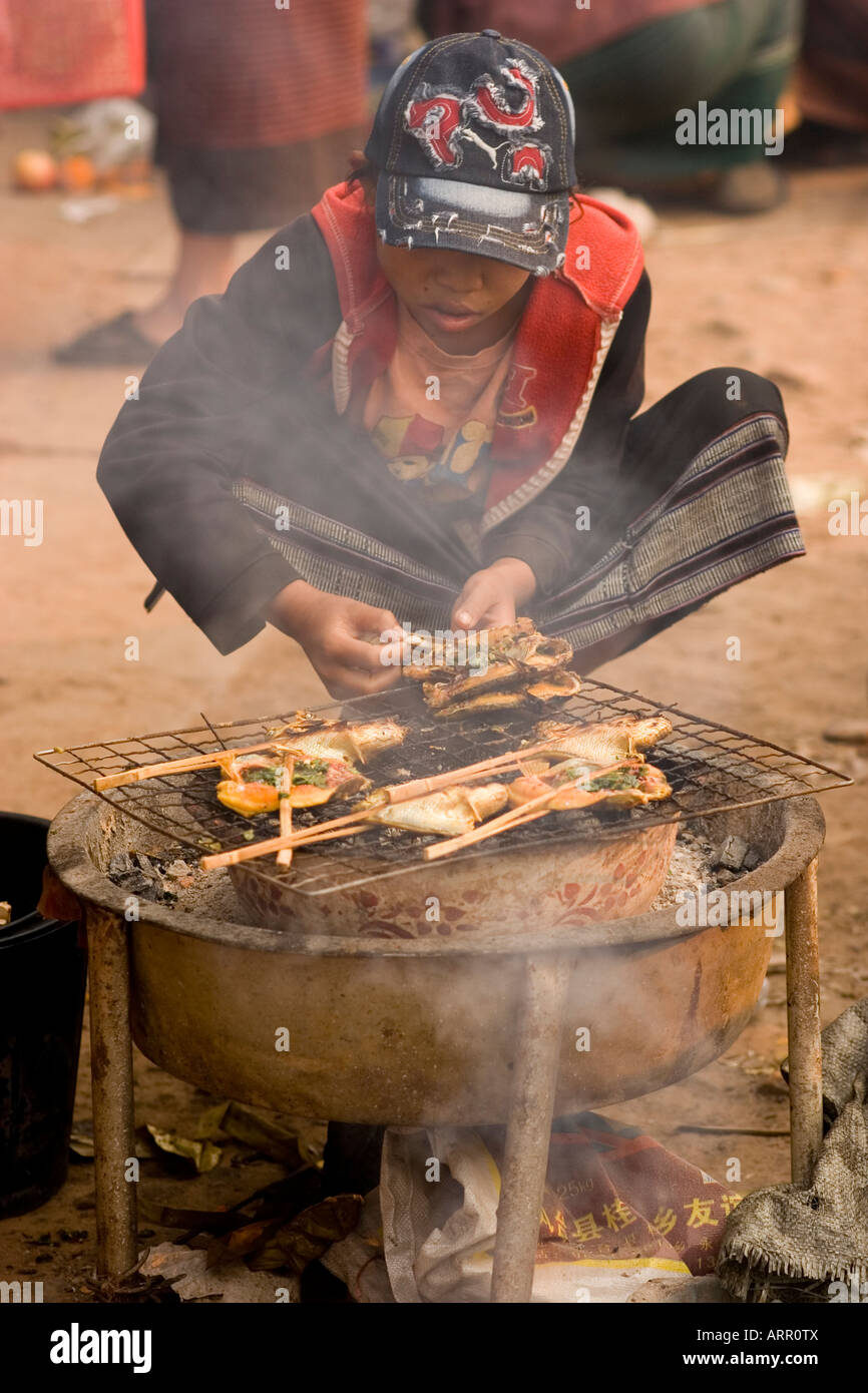Young girl gilling fish market Muang Sing Laos Stock Photo - Alamy