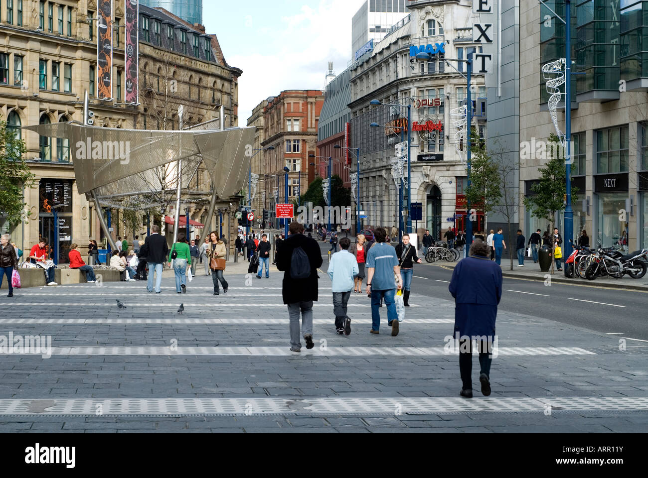 People walking in Exchange Square Manchester City Centre UK Stock Photo ...