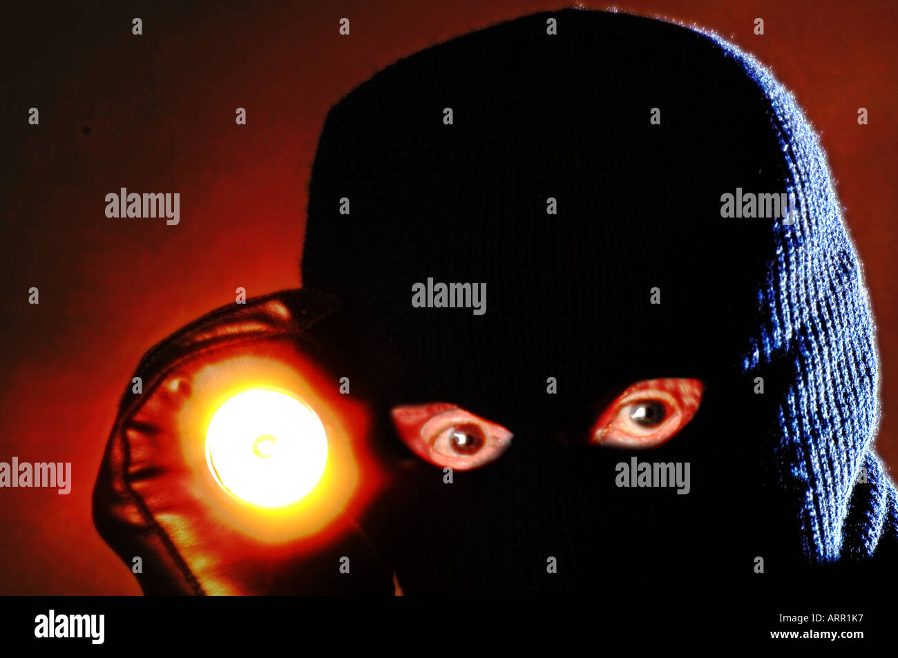 man with flashlight wearing ski mask breaking into bank vault Stock ...