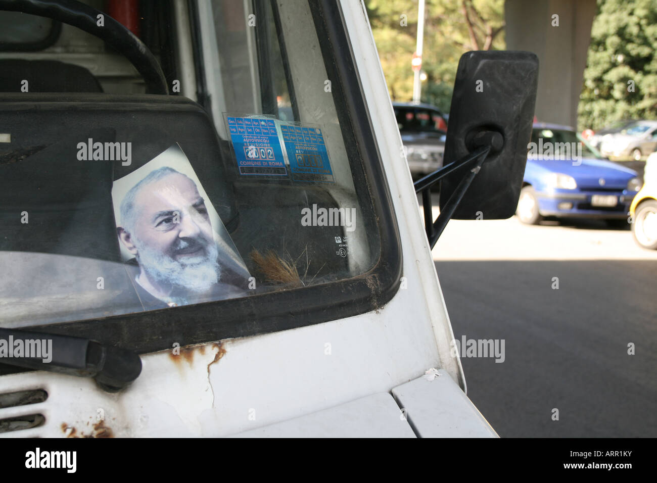 padre pio image in car window in rome italy Stock Photo - Alamy