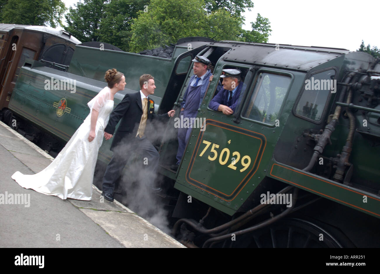 bride and groom catching a train on wedding day Stock Photo - Alamy