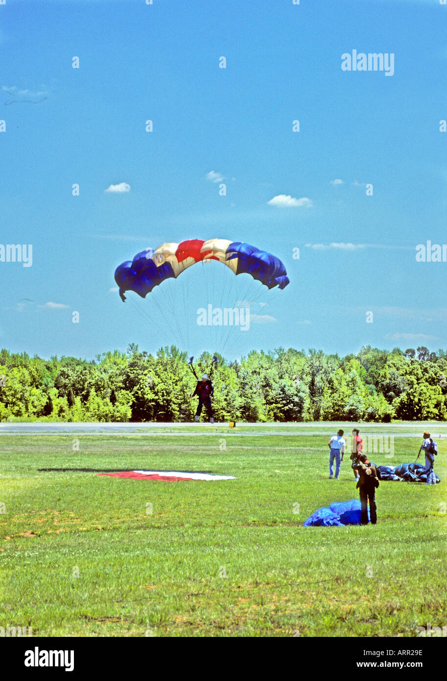 Colorful parachute landing on target Stock Photo - Alamy
