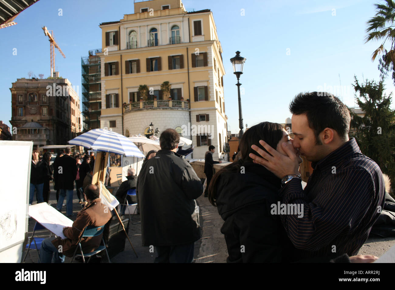 young couple kissing on the top of the spanish steps in roma italy ...